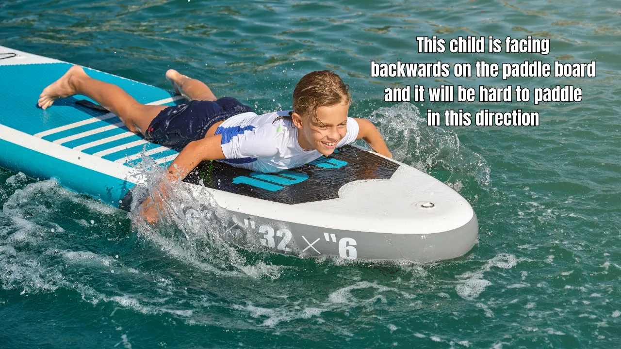 child-facing-backwards-on-paddle-board - Hunting Waterfalls